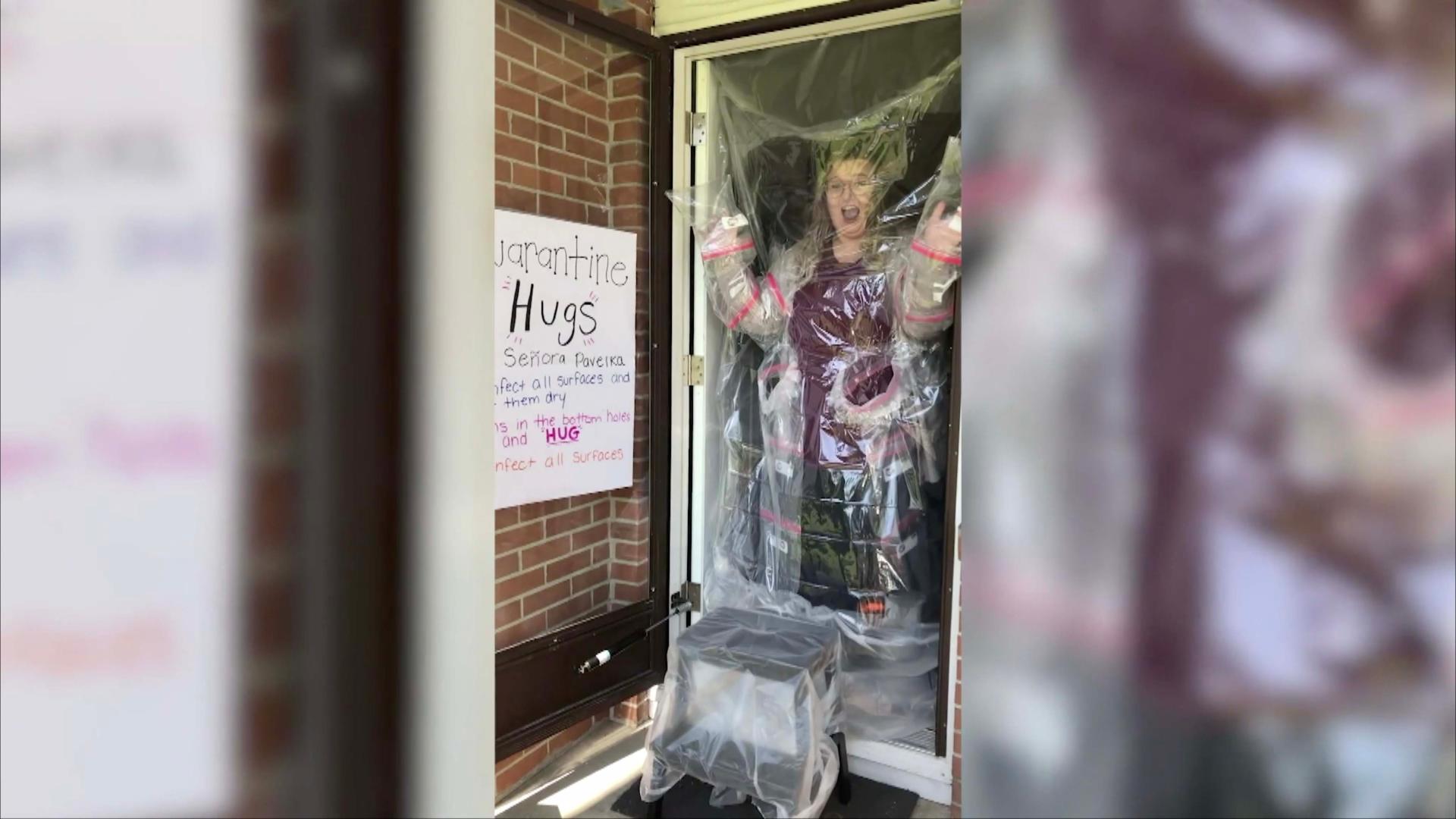 Teacher improvises a 'free hugs booth' that's pandemic safe - CGTN
