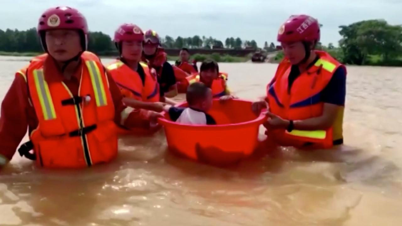 Firefighters use basin to transfer sick baby to hospital through flood ...