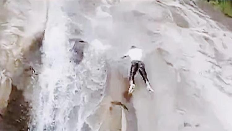Man escapes with scratches after falling down rocky waterfall - CGTN