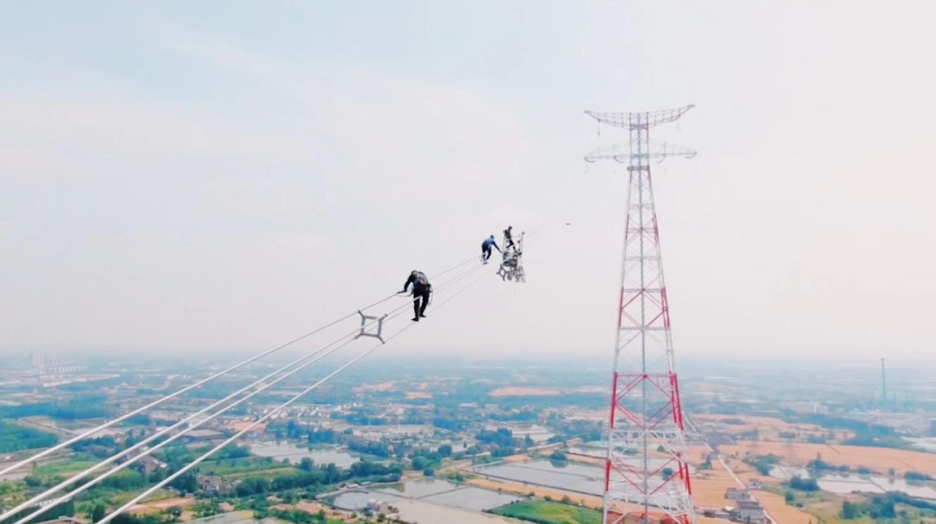 Cable stringing underway for world's highest transmission towers - CGTN