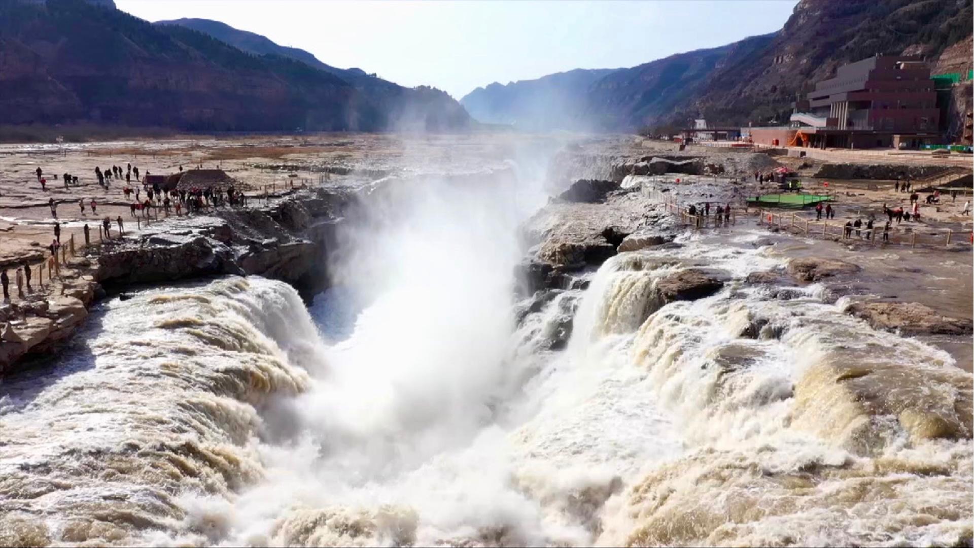 N China's Hukou waterfall gushes as weather gets warmer - CGTN